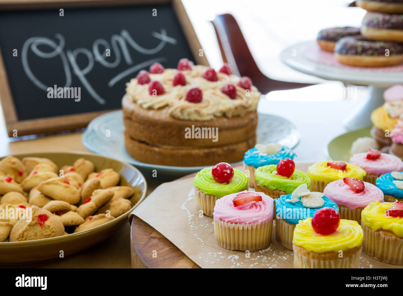 Close-up of various sweet foods on table with open signboard Stock ...