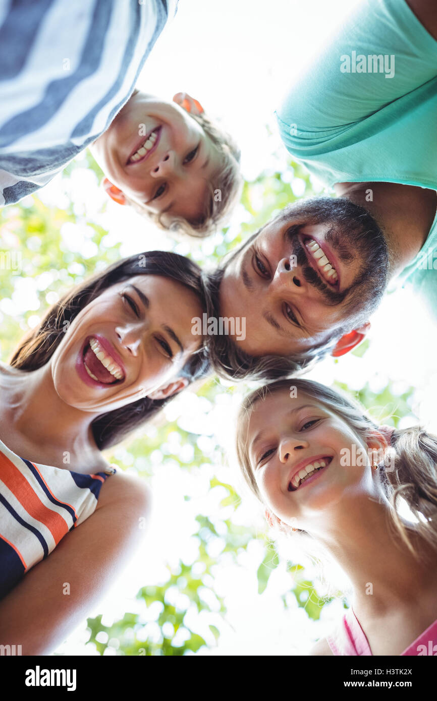 Family forming huddle against sky Stock Photo - Alamy