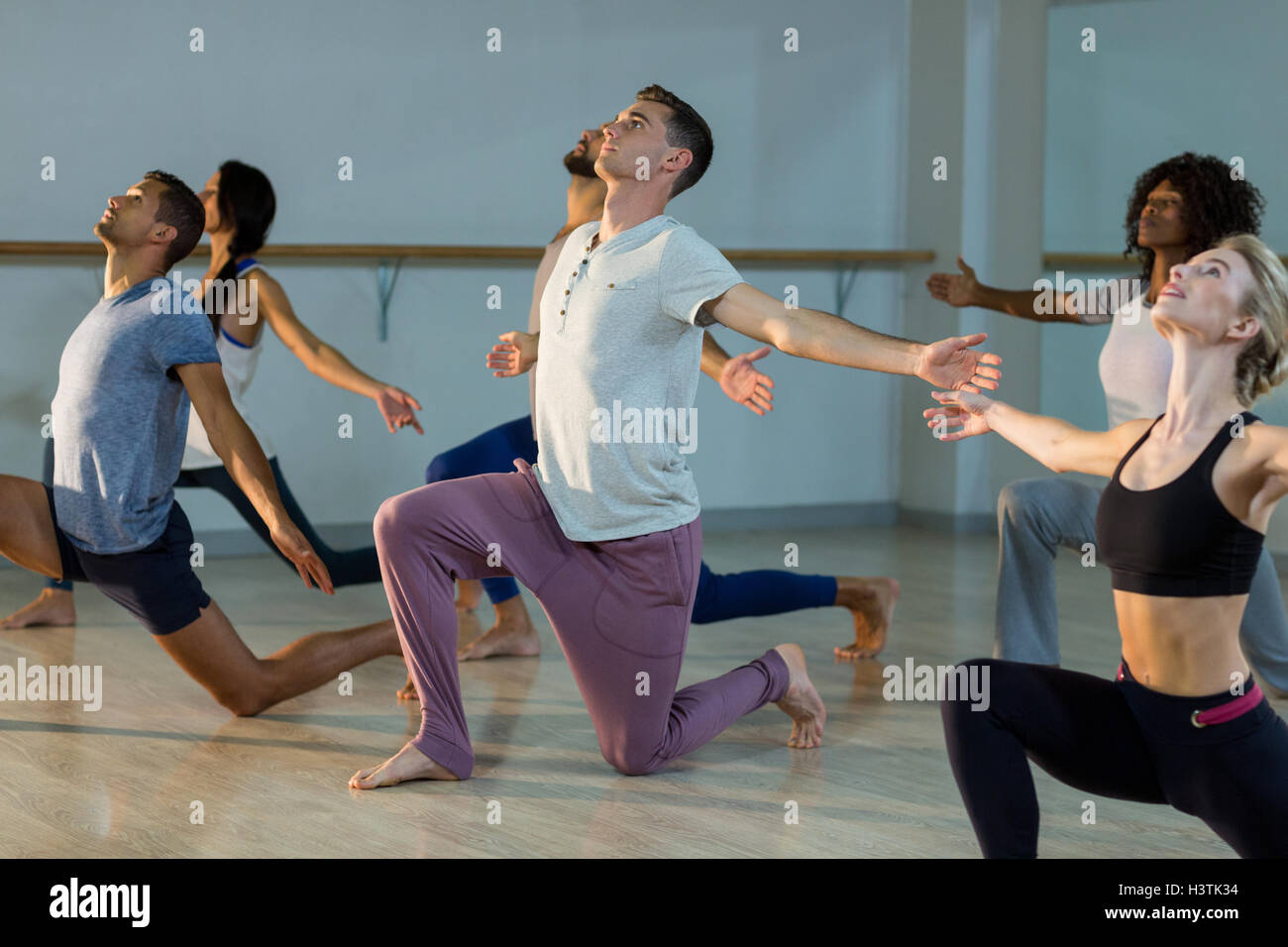 Group of people performing stretching exercise Stock Photo - Alamy
