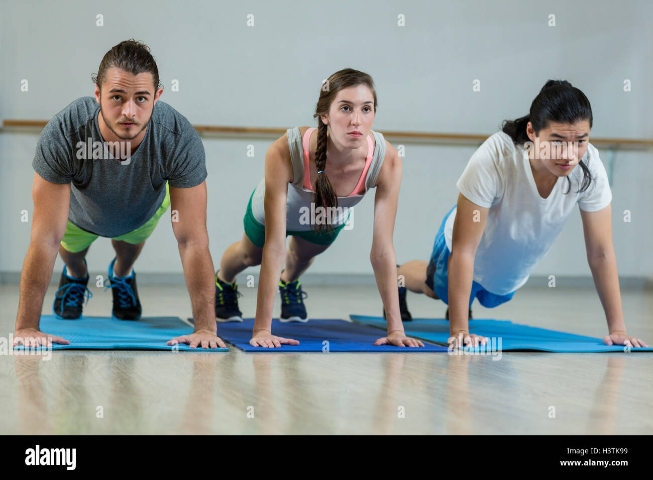 Group of fitness team doing push ups Stock Photo - Alamy