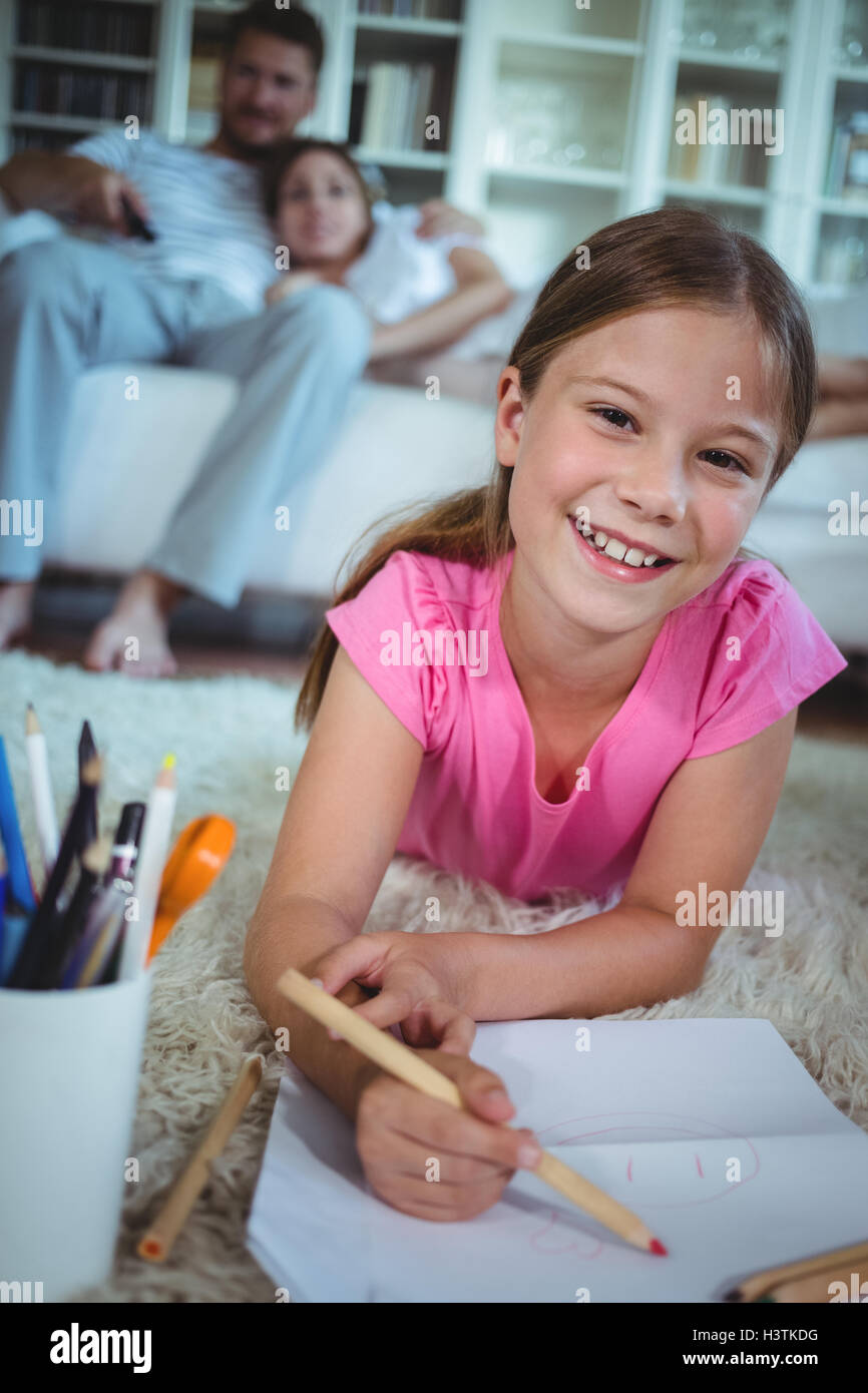 Girl lying on the floor and drawing Stock Photo - Alamy
