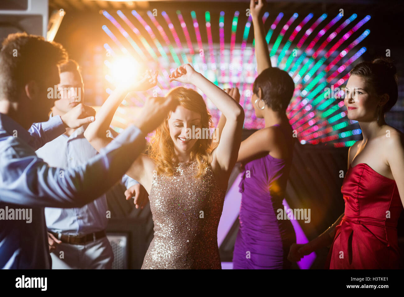 Smiling friends dancing on dance floor Stock Photo - Alamy
