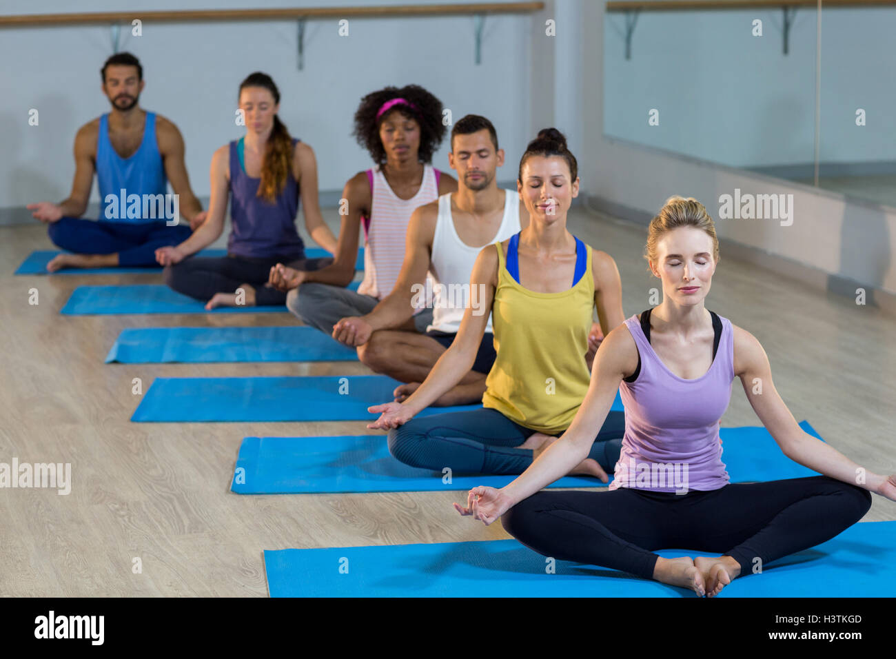 Group of people performing yoga Stock Photo - Alamy