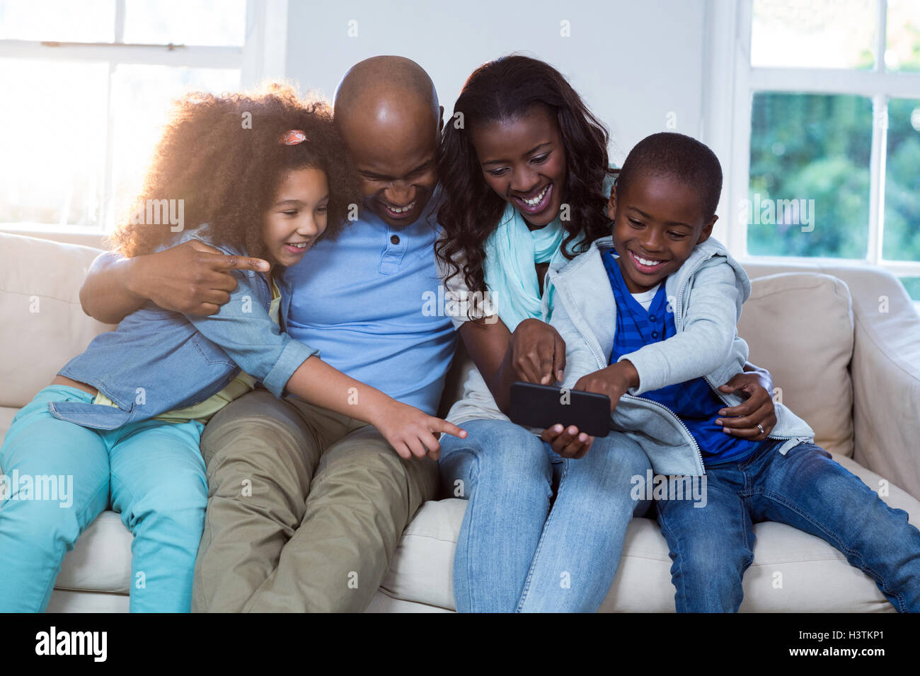 Family using mobile phone Stock Photo - Alamy