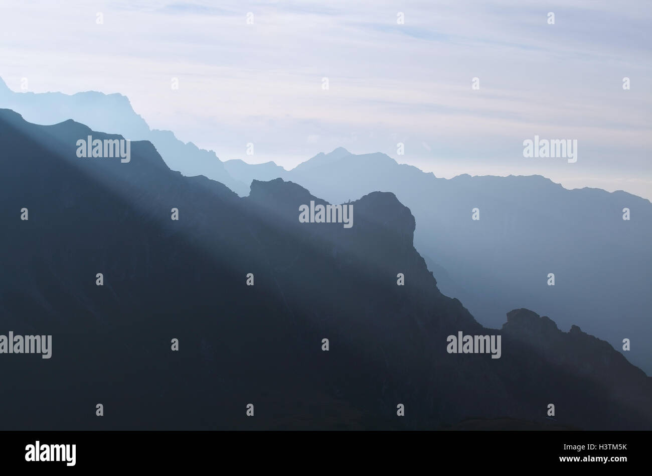 misty rock silhouette in dusk, Alps Stock Photo - Alamy