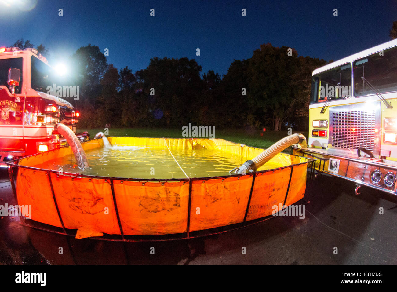Two fire engines and a water tank for pumping Stock Photo - Alamy