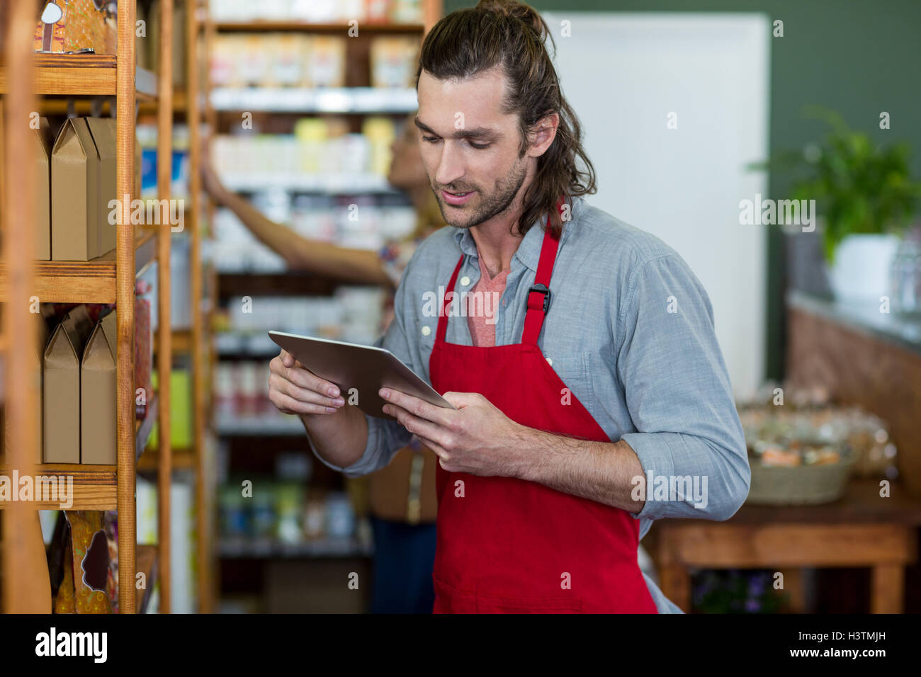 Male staff using a digital tablet Stock Photo - Alamy