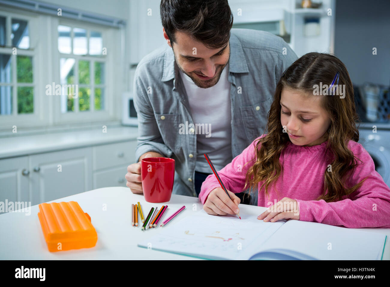 Father helping girl with homework Stock Photo - Alamy