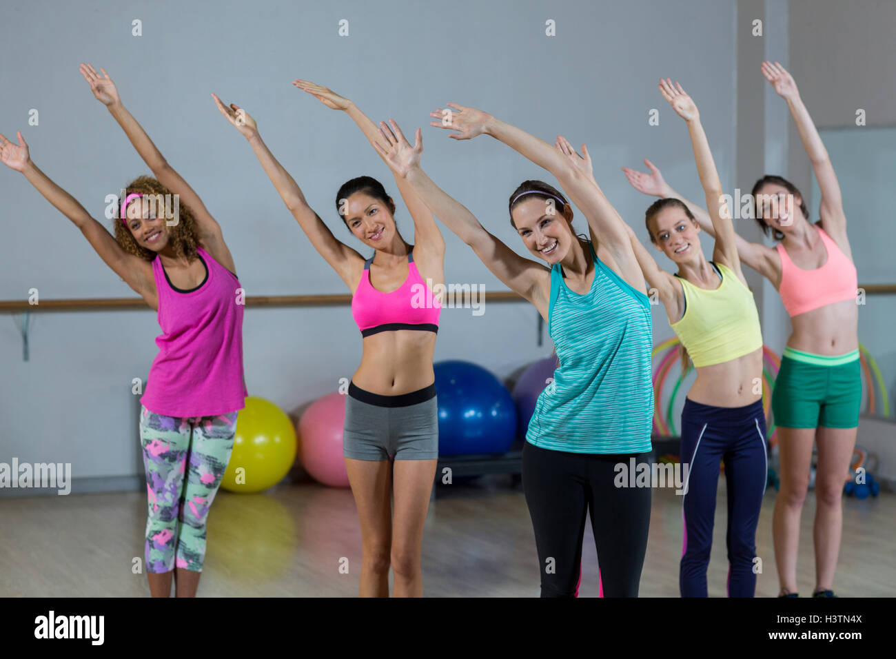 Group of fitness team performing stretching exercise Stock Photo - Alamy