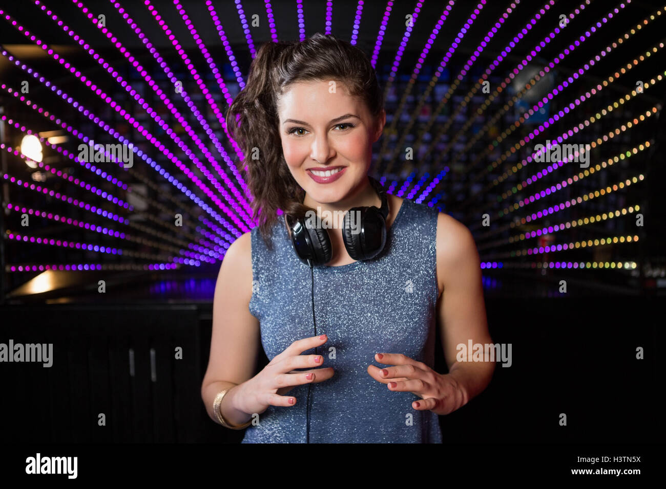 Pretty female DJ playing music Stock Photo - Alamy