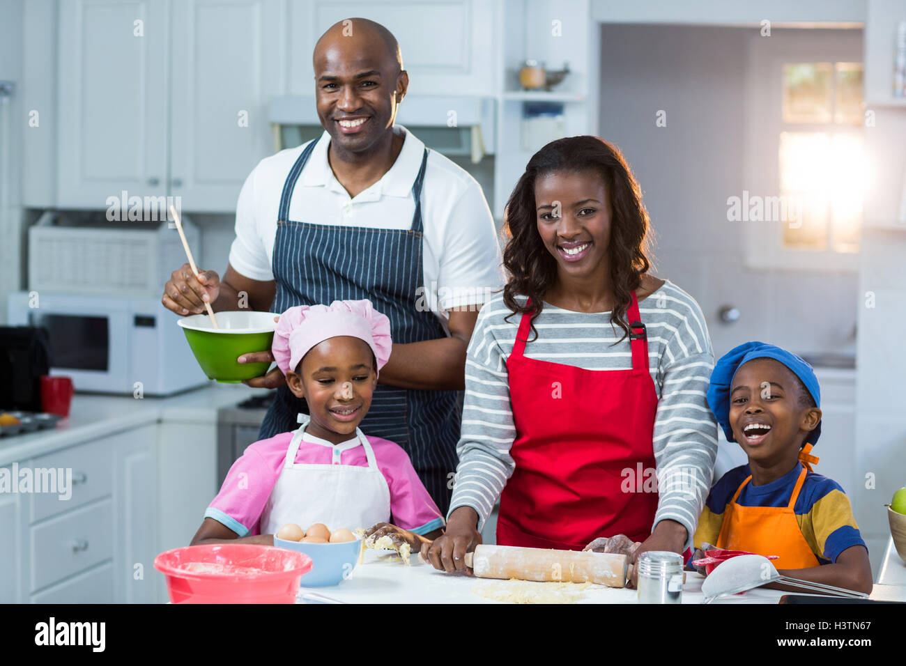 Family preparing cake Stock Photo - Alamy