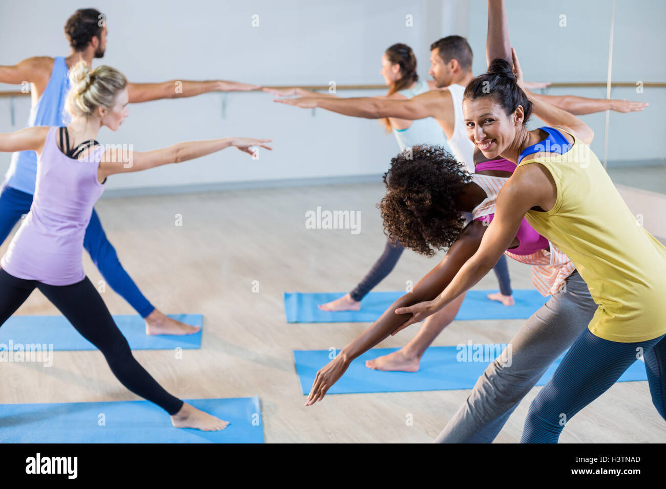 Yoga instructor helping student with a correct pose Stock Photo - Alamy