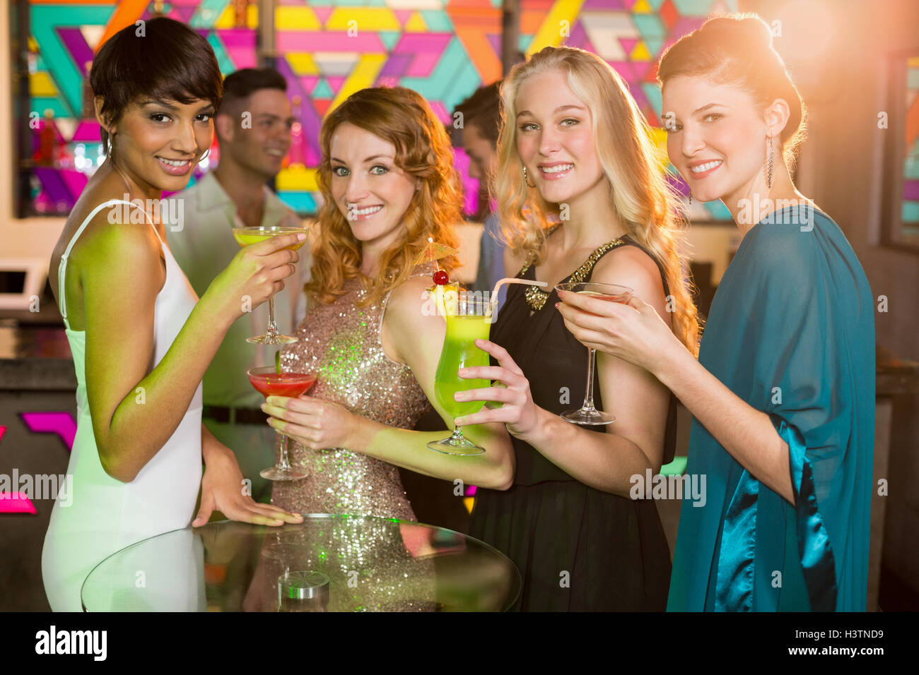 Group of friends having glass of cocktail in bar Stock Photo - Alamy