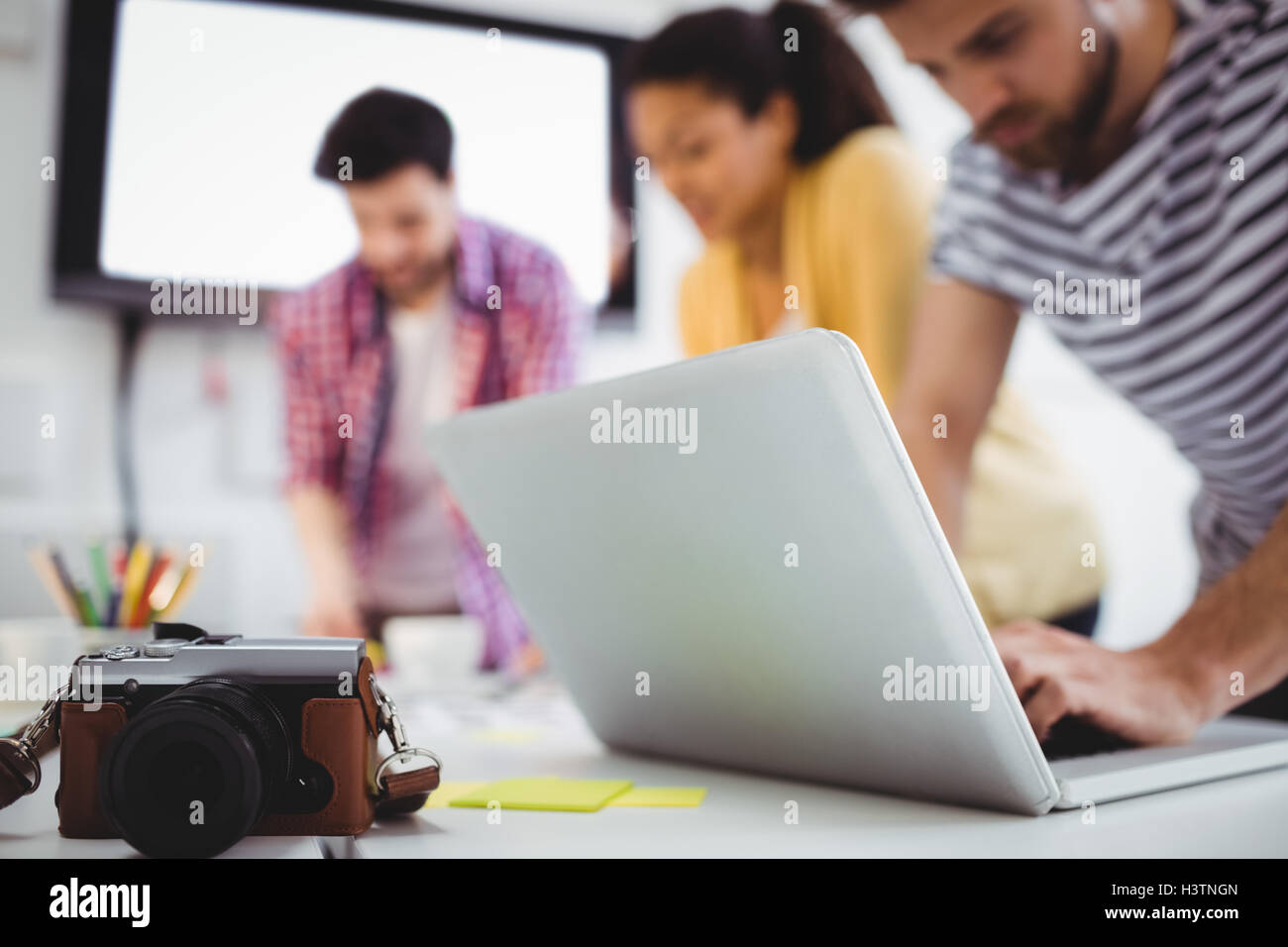 Close-up of camera on desk with executive working at creative office ...