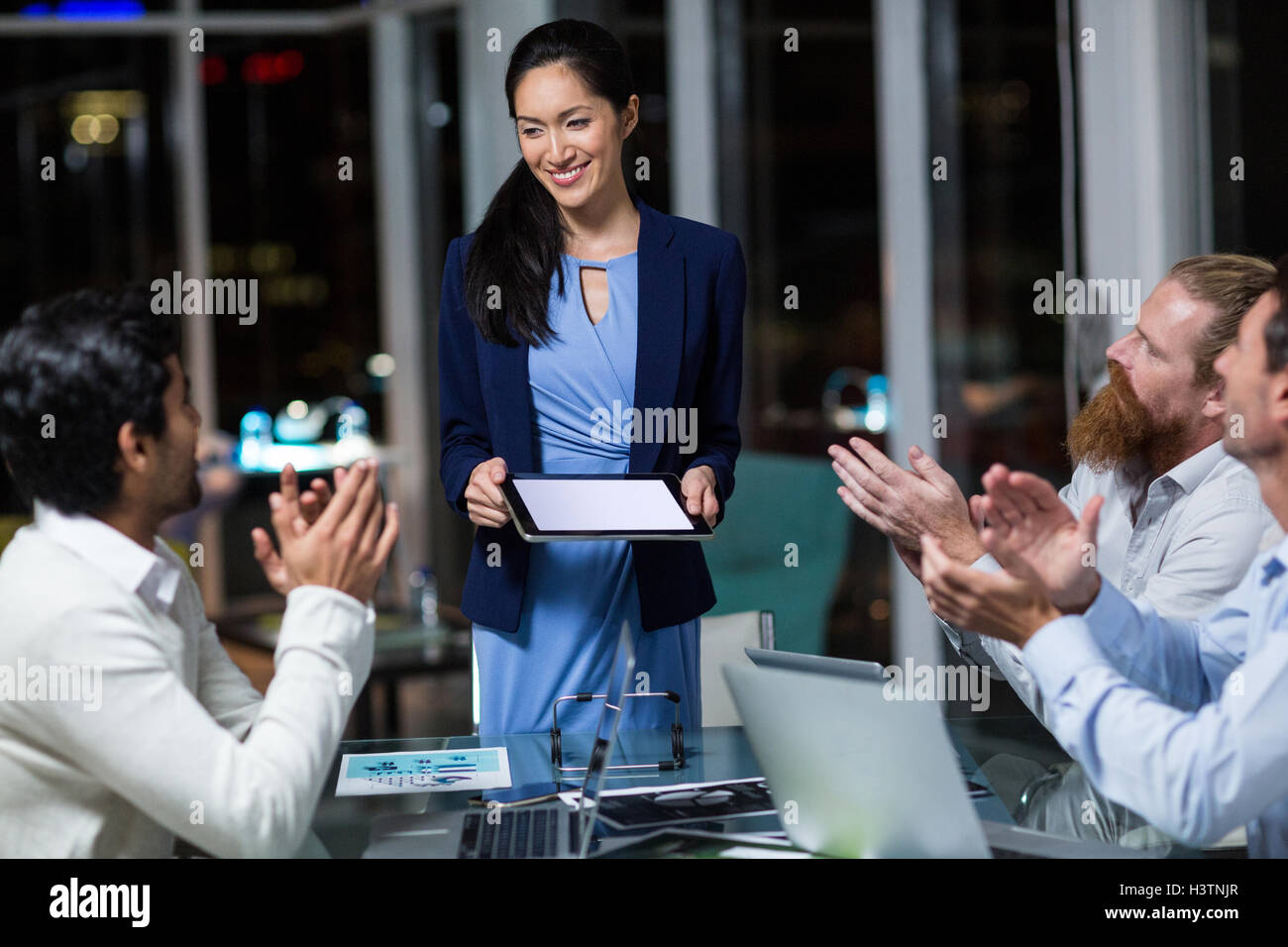 Coworkers applauding a colleague after presentation Stock Photo - Alamy