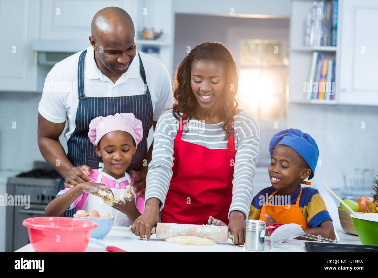 Family preparing cake Stock Photo - Alamy