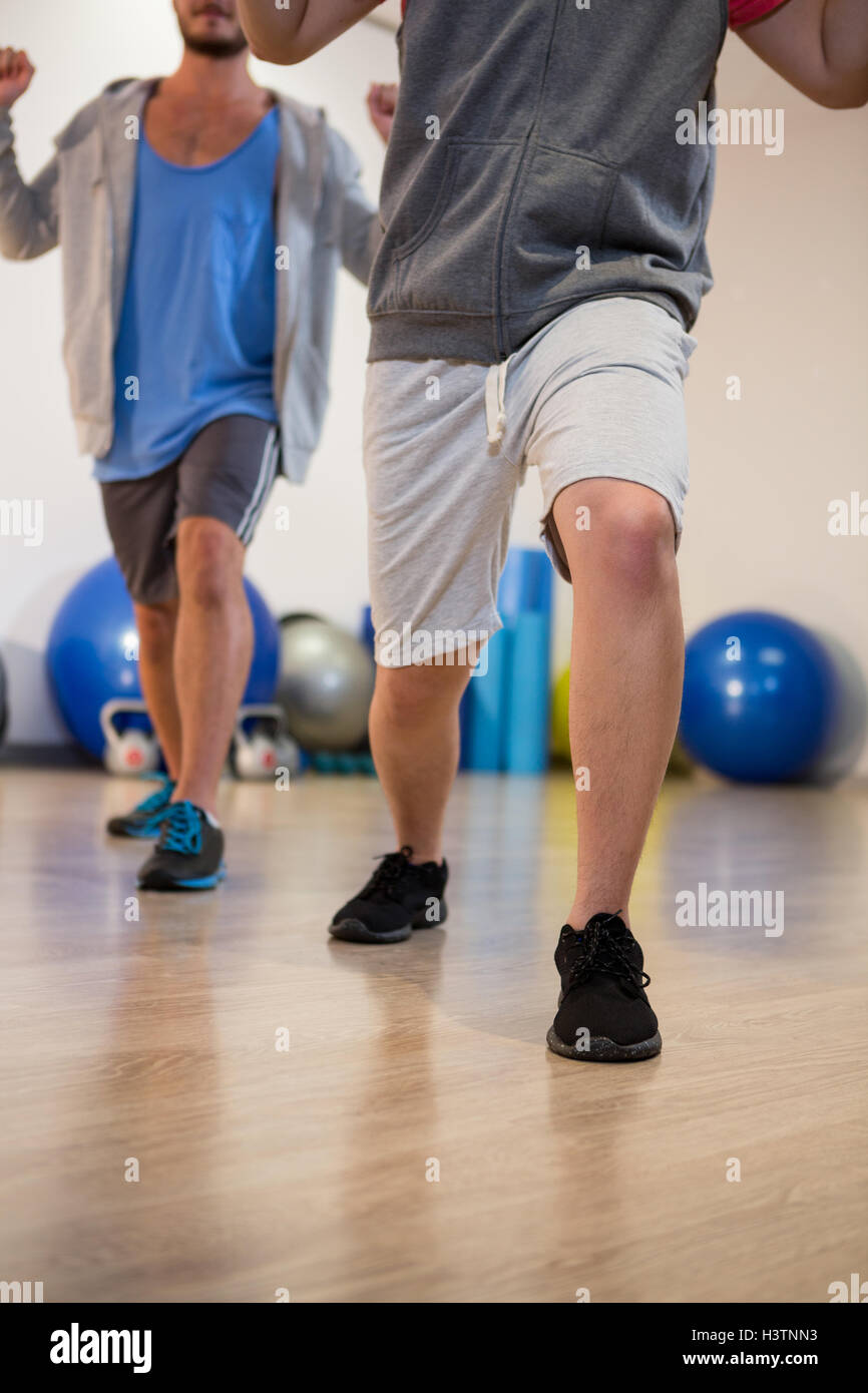 Men performing stretching exercise Stock Photo - Alamy