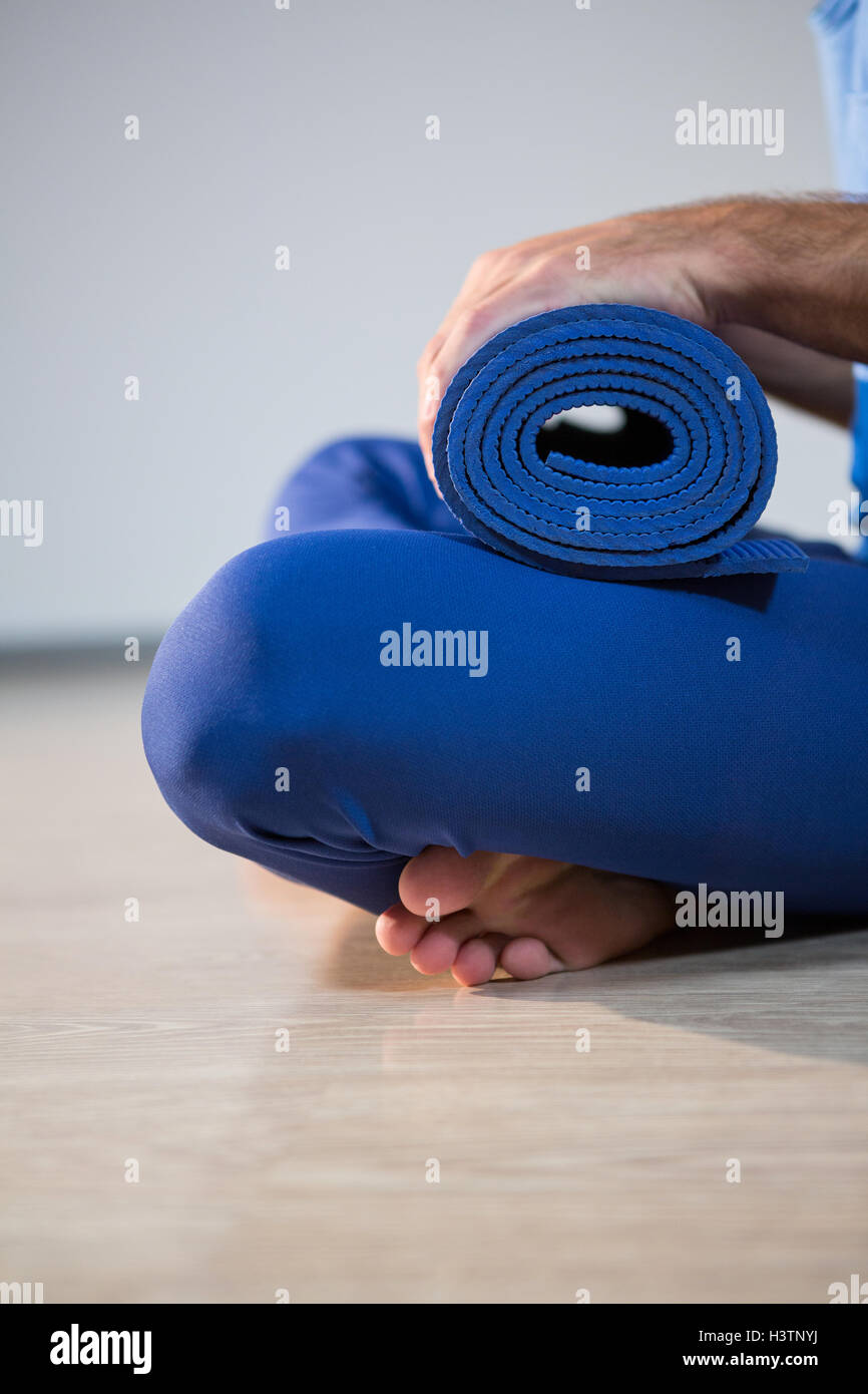 Man holding exercise mat Stock Photo - Alamy