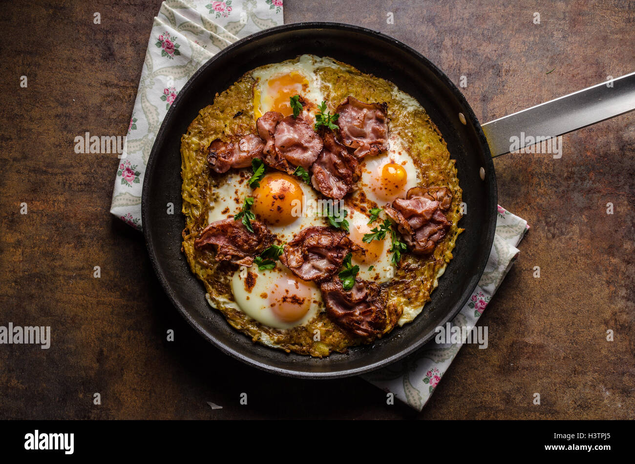 American Hash Browns potato with fried egg, bacon and herbs, real ...