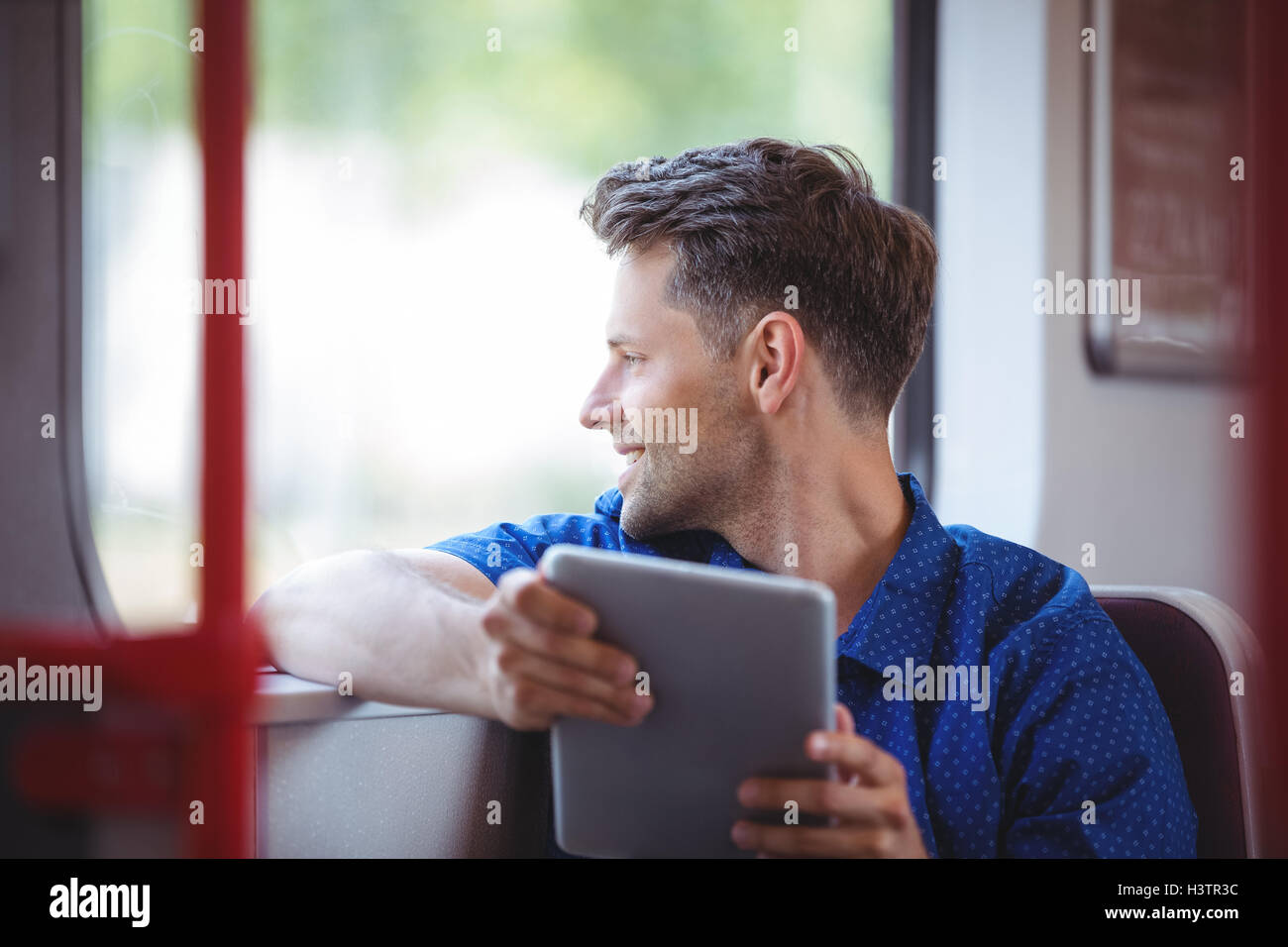 Handsome man looking through window Stock Photo - Alamy