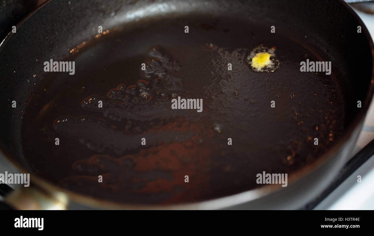 Frying pan with oil Stock Photo - Alamy