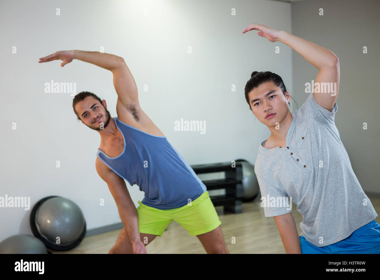 Smiling two men doing aerobic exercise Stock Photo - Alamy