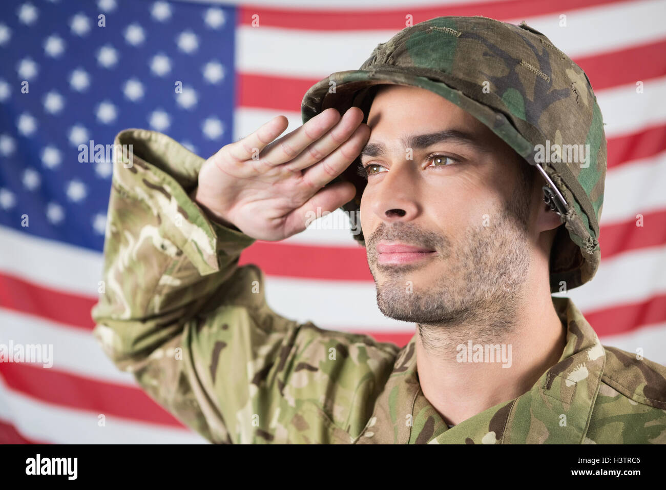 Confident soldier saluting Stock Photo - Alamy