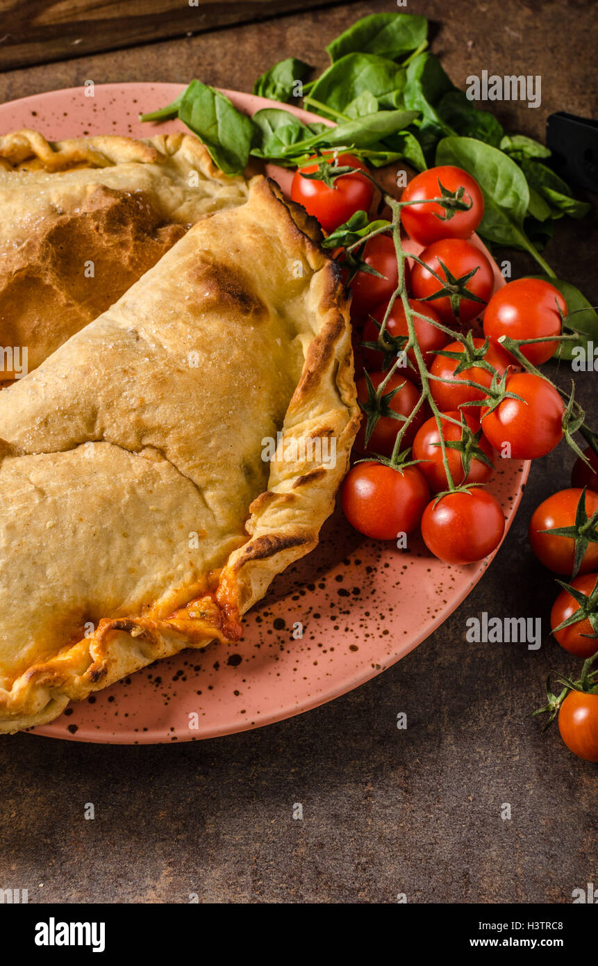 Calzone pizza, stuffed with tomato and herbs sauce, baked to crispy Stock Photo - Alamy