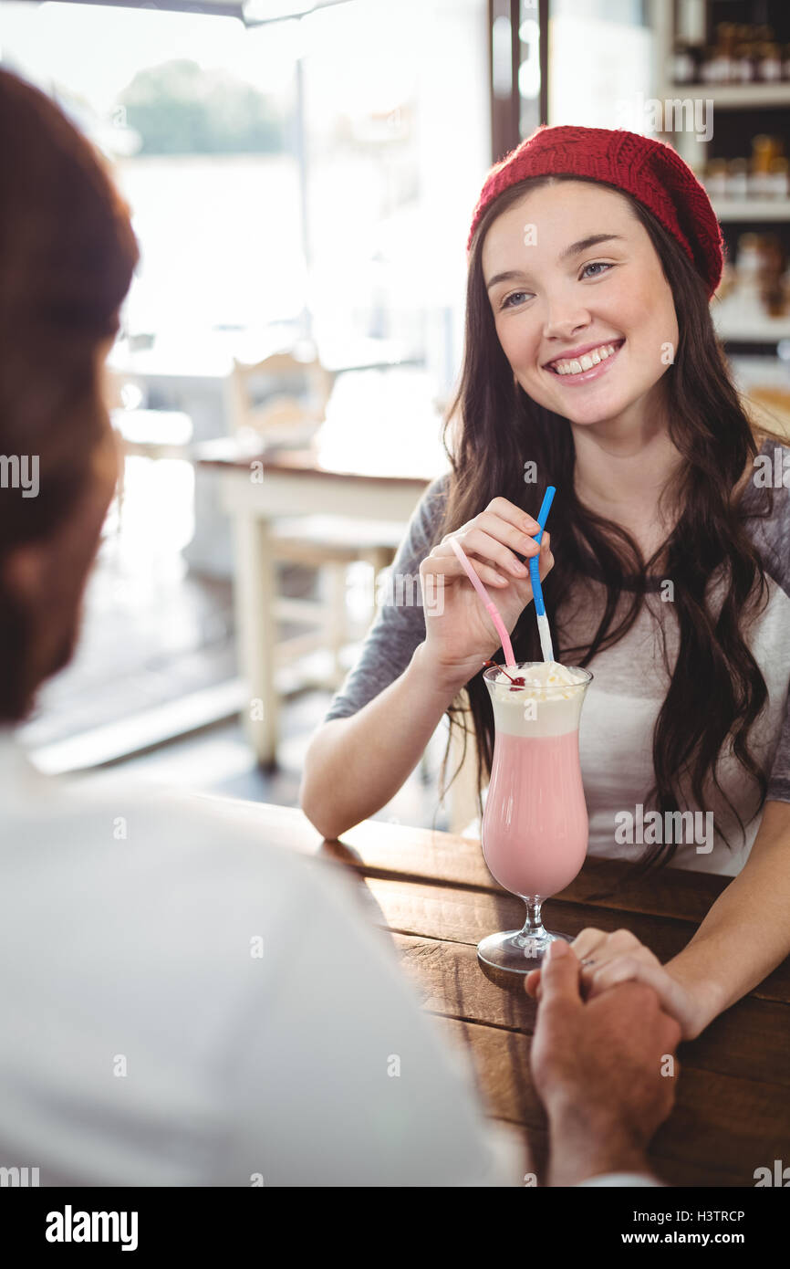 Couple drinking milkshake with a straw Stock Photo - Alamy