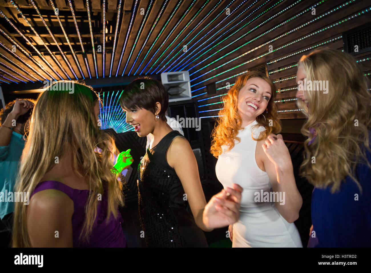 Group of smiling friends dancing on dance floor Stock Photo - Alamy