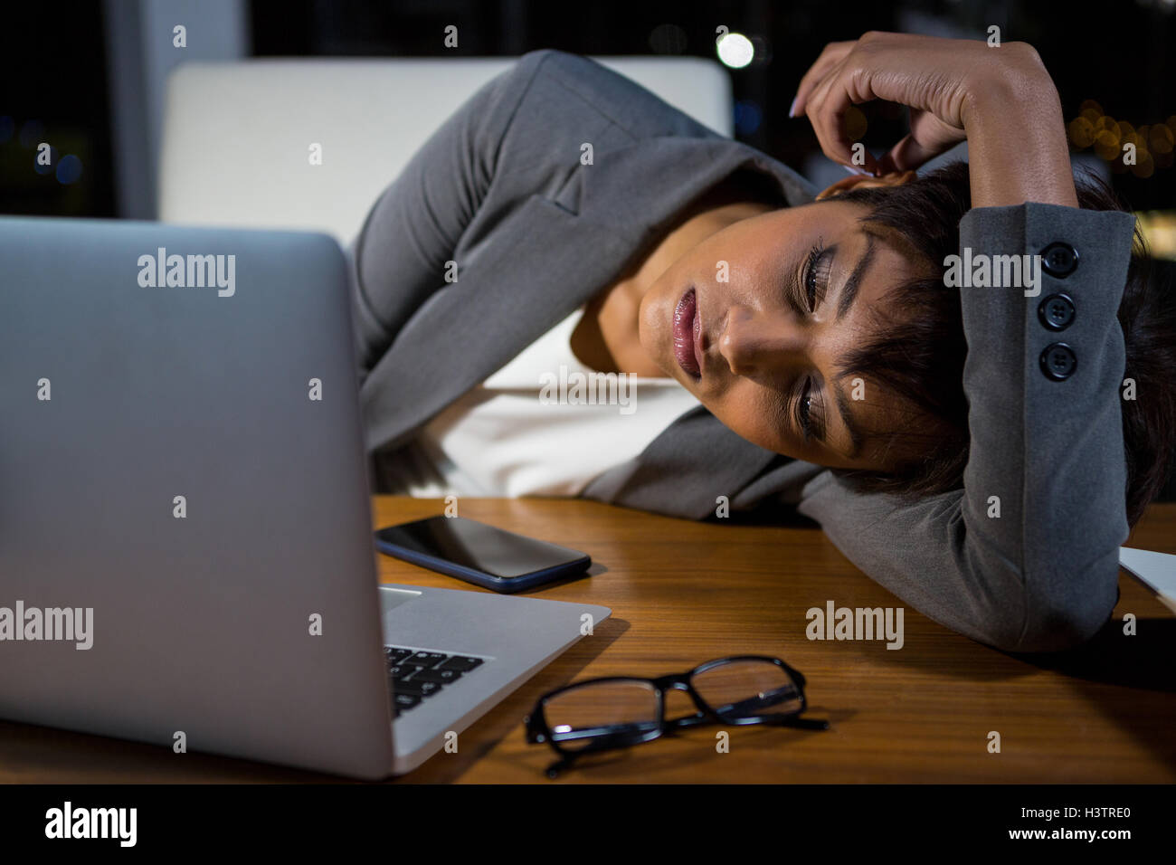 Tired businesswoman sleeping on the desk Stock Photo - Alamy