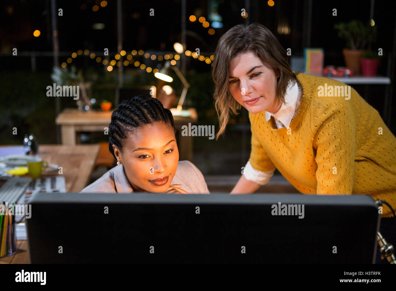 Women looking at computer Stock Photo - Alamy
