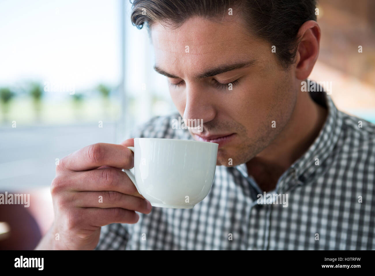 Man having coffee in coffee shop Stock Photo - Alamy