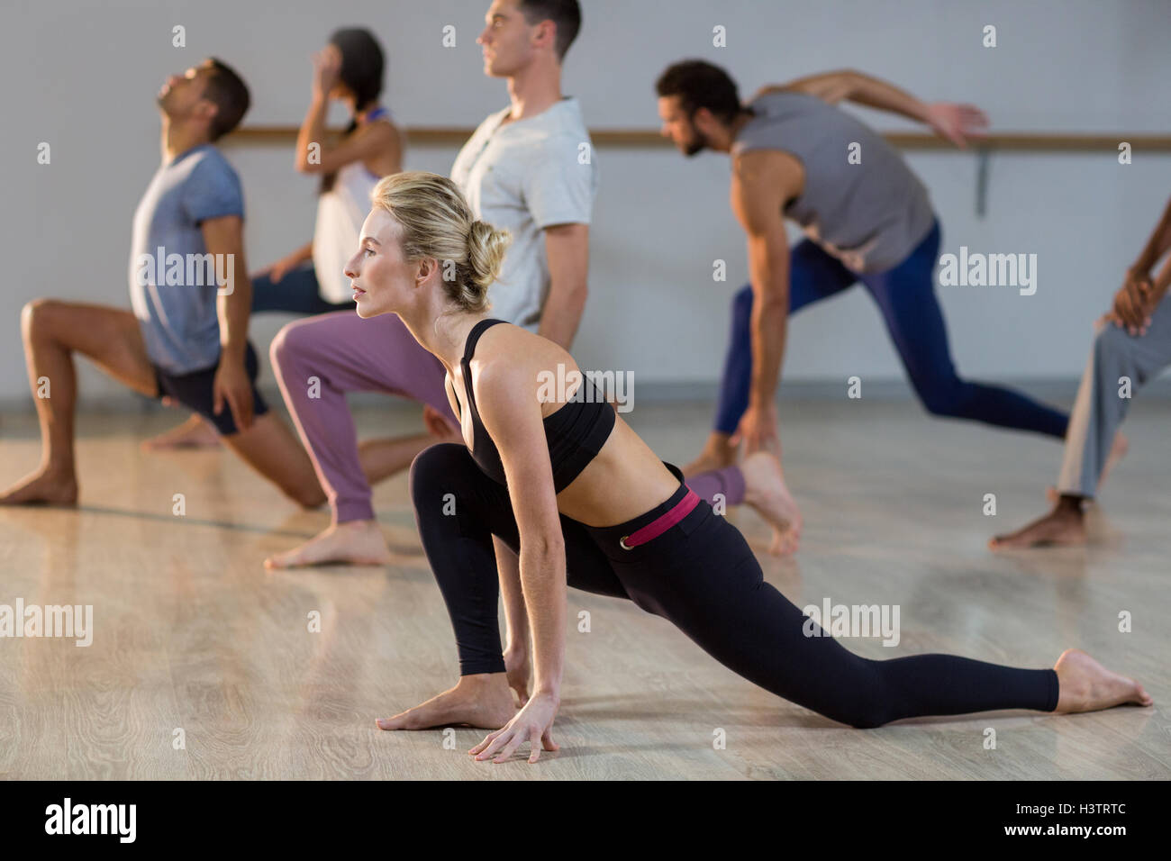 Group of people performing stretching exercise Stock Photo - Alamy