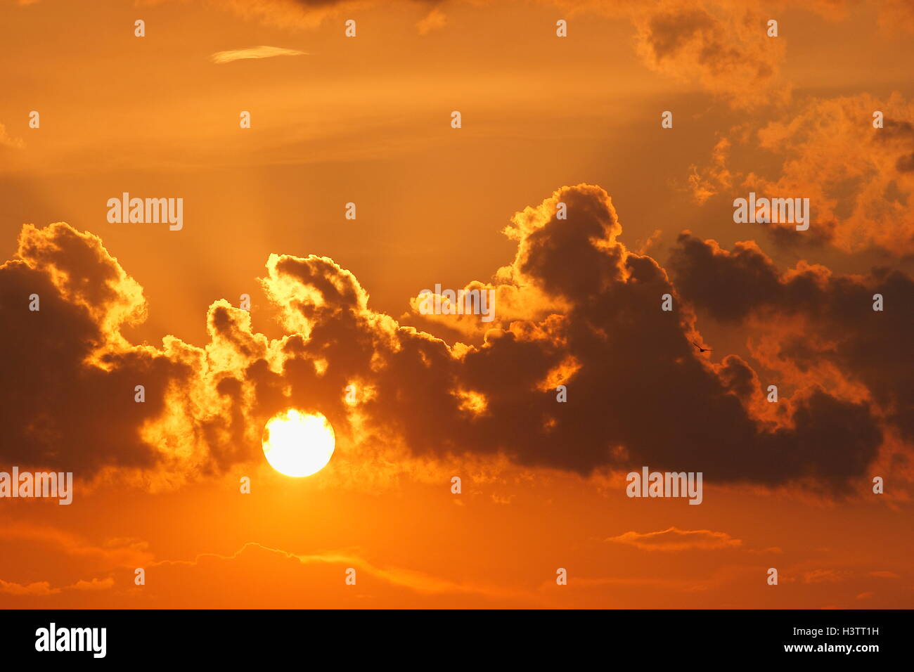 Atmospheric Sunset with dark clouds Stock Photo - Alamy