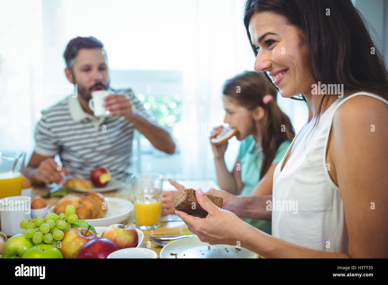Woman smiling while have breakfast Stock Photo - Alamy