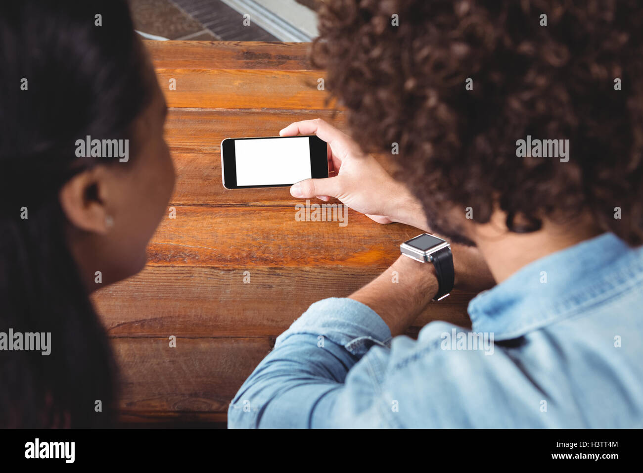 Couple looking at mobile phone Stock Photo - Alamy