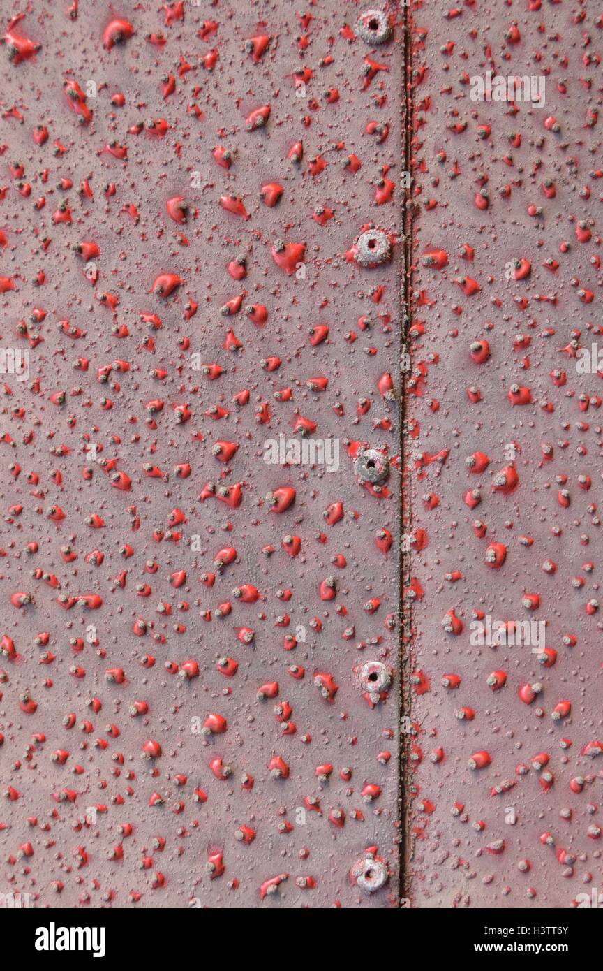 Sheet metal with red dots. Photo of a sheet metal with a red background ...