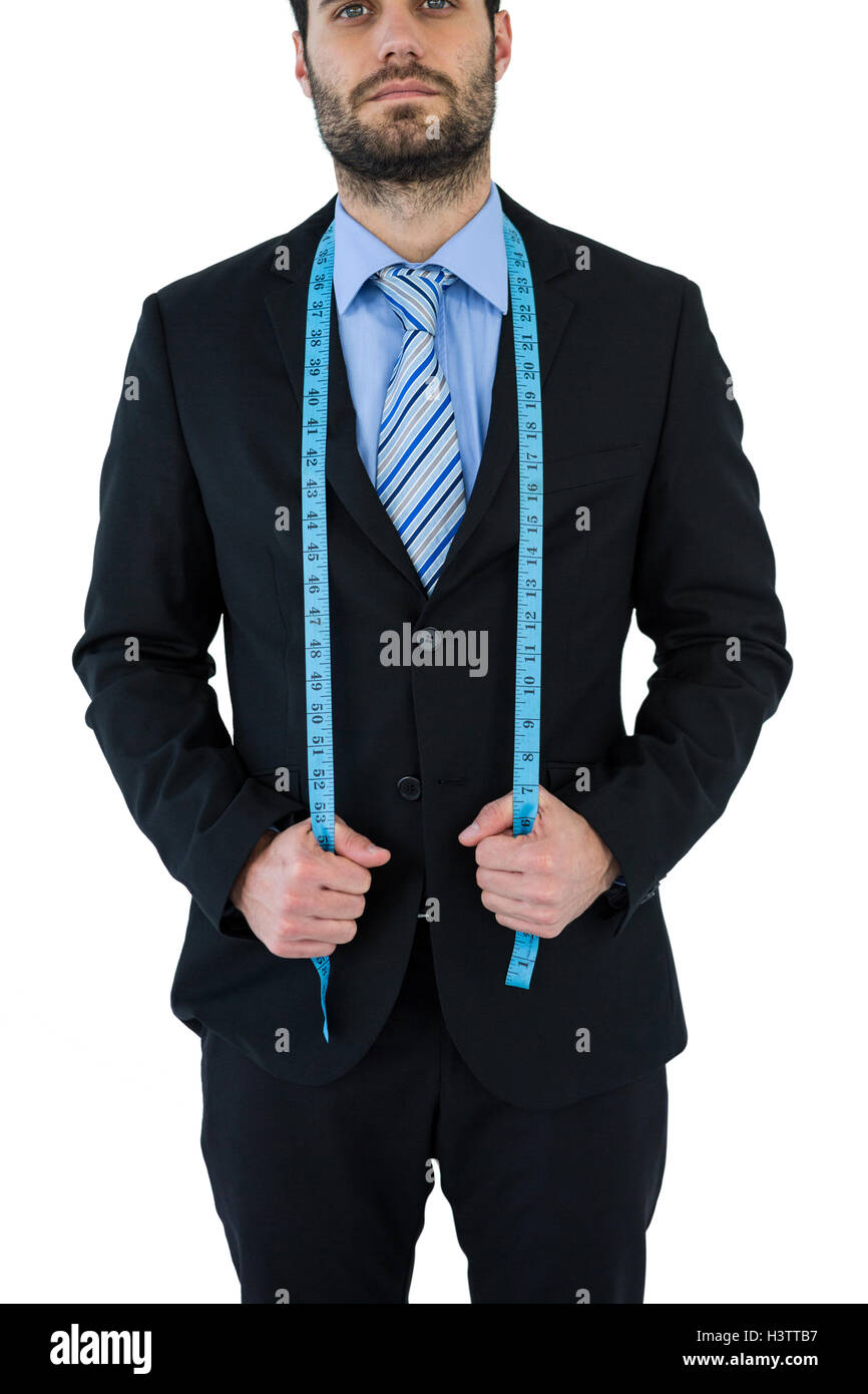 Portrait of businessman holding measuring tape Stock Photo - Alamy