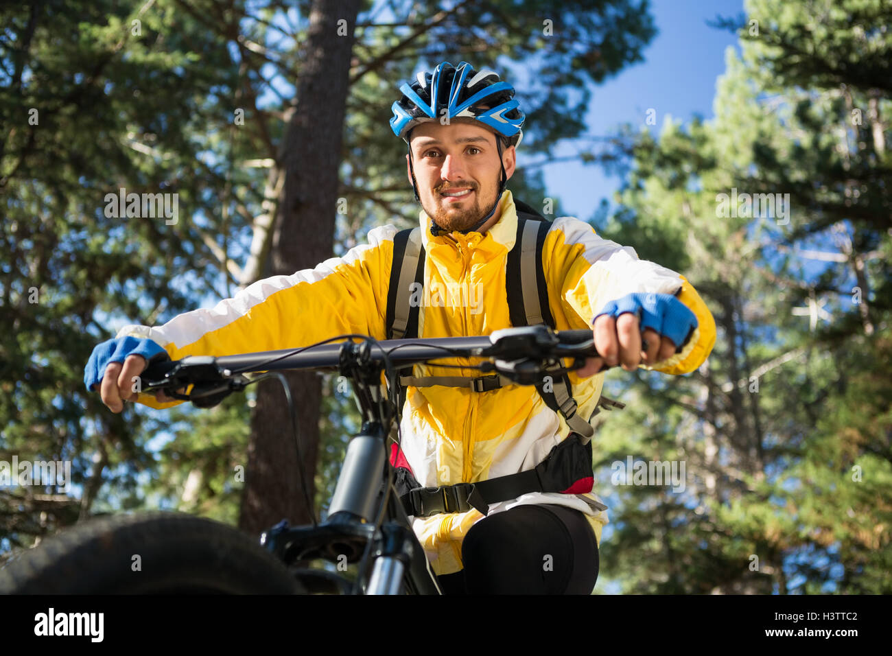 Male mountain biker riding bicycle in the forest Stock Photo - Alamy