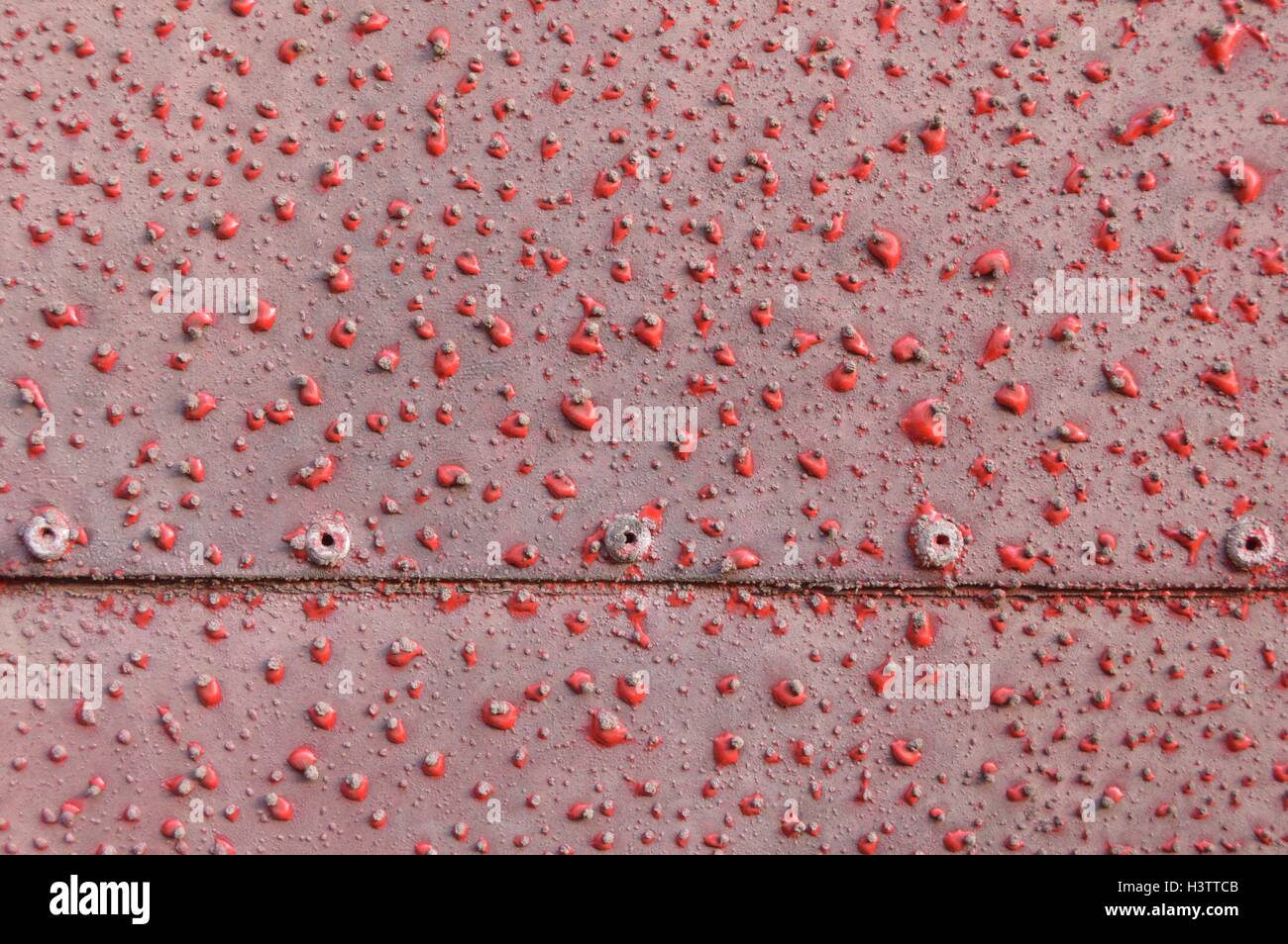 Sheet metal with red dots. Photo of a sheet metal with a red background ...