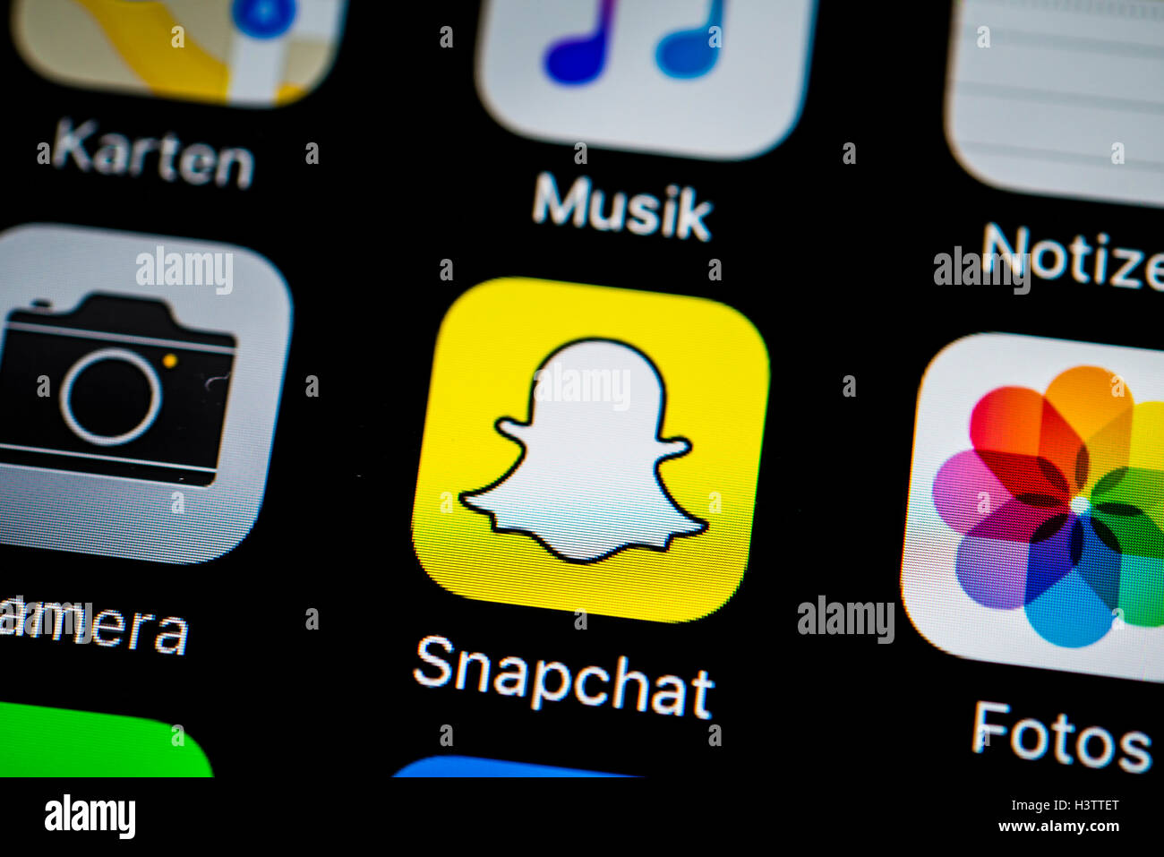 Smartphone screen display with Photos and Snapchat app icons in detail ...