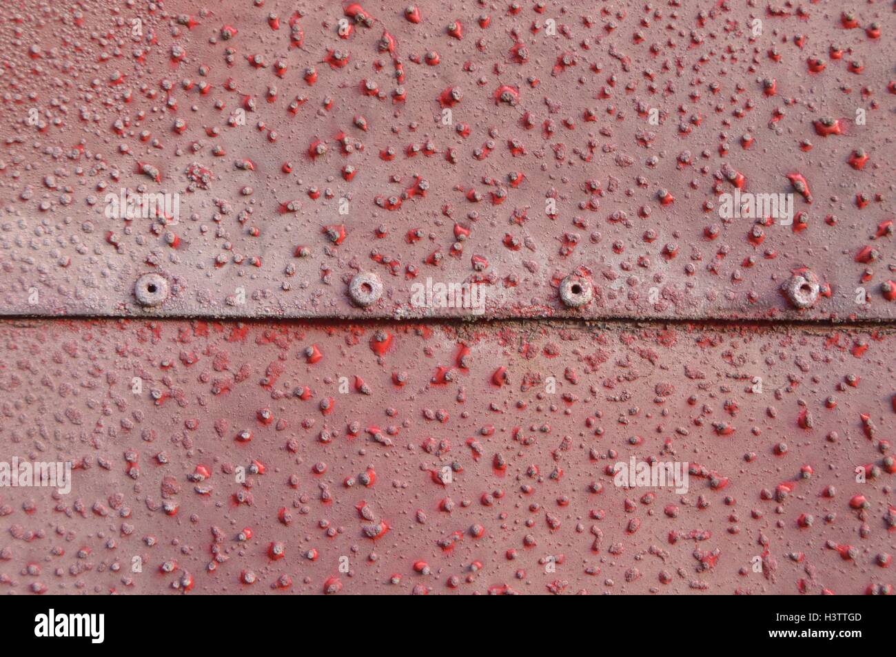 Sheet metal with red dots. Photo of a sheet metal with a red background ...
