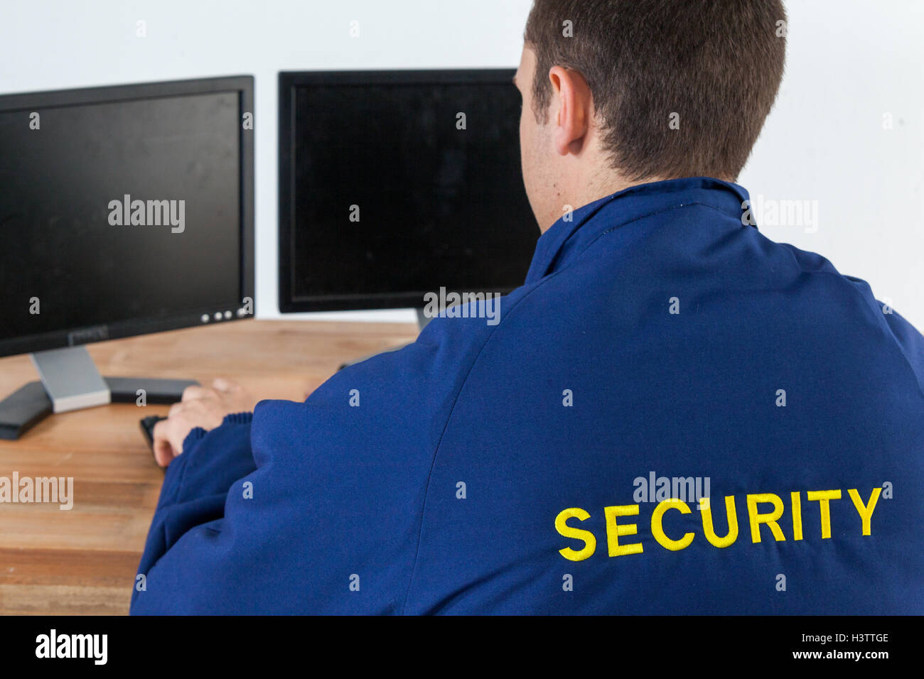 Security officer using computer Stock Photo - Alamy