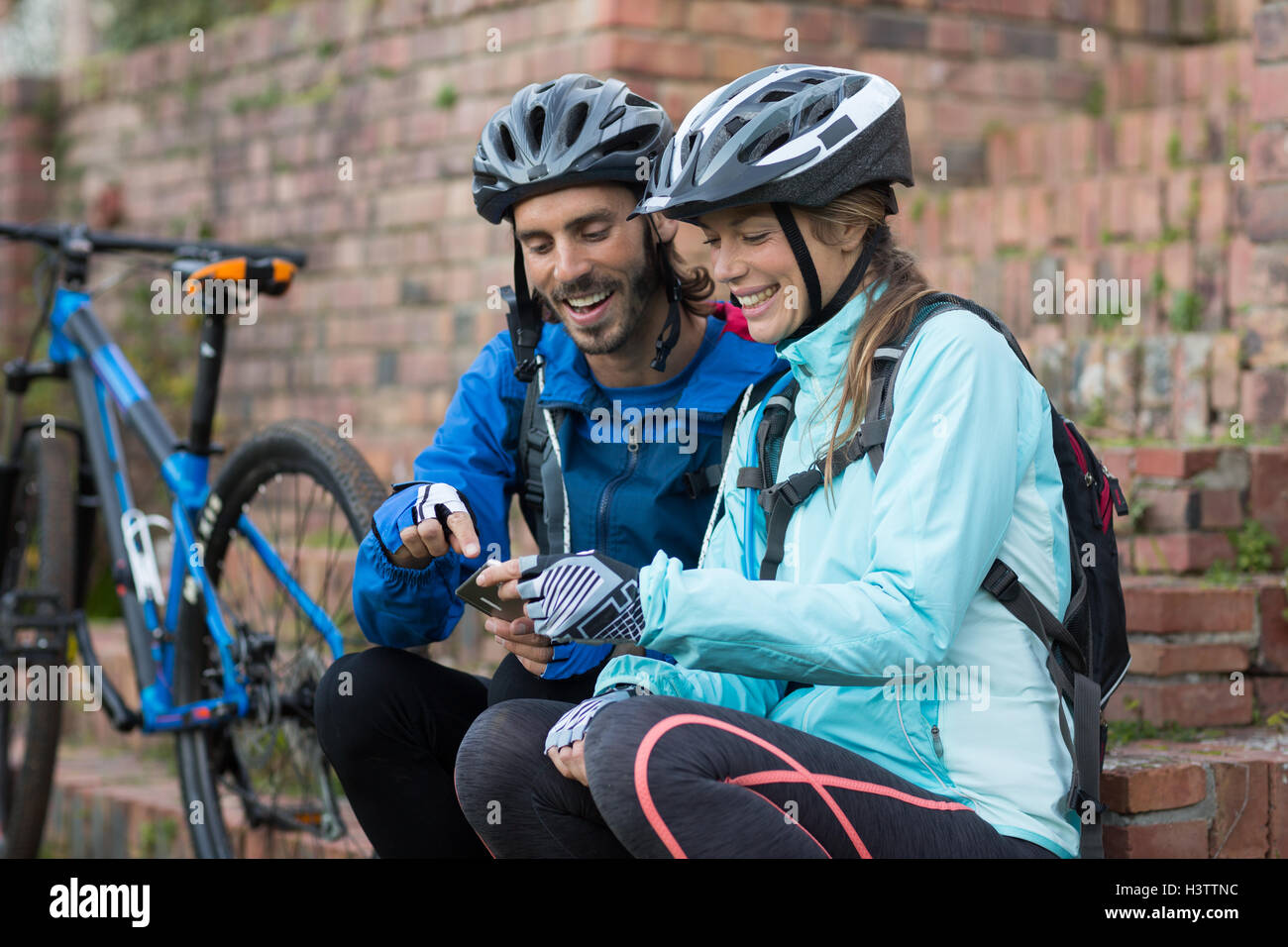 Cyclist using mobile phone hi-res stock photography and images - Alamy