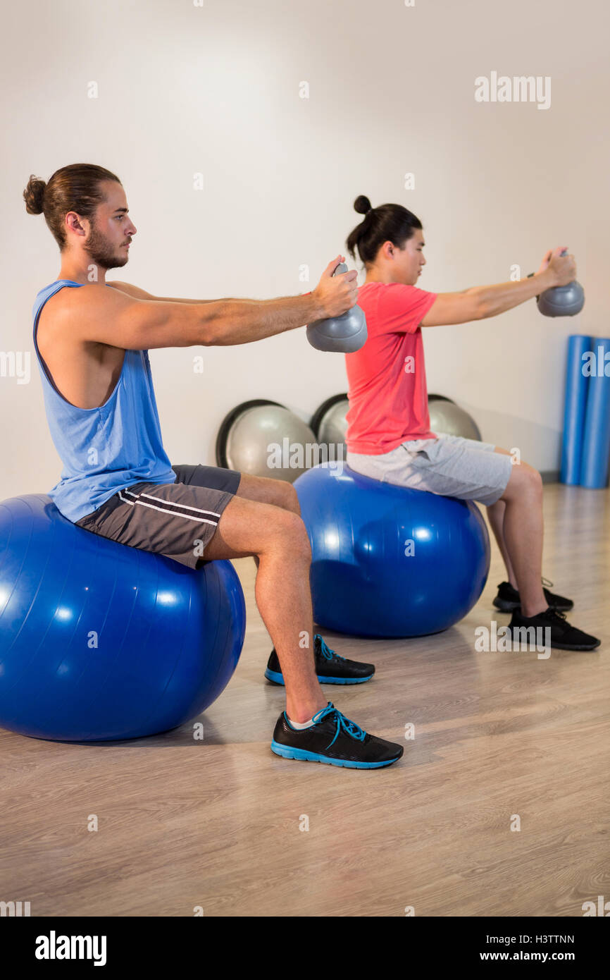 Men performing stretching exercise Stock Photo - Alamy