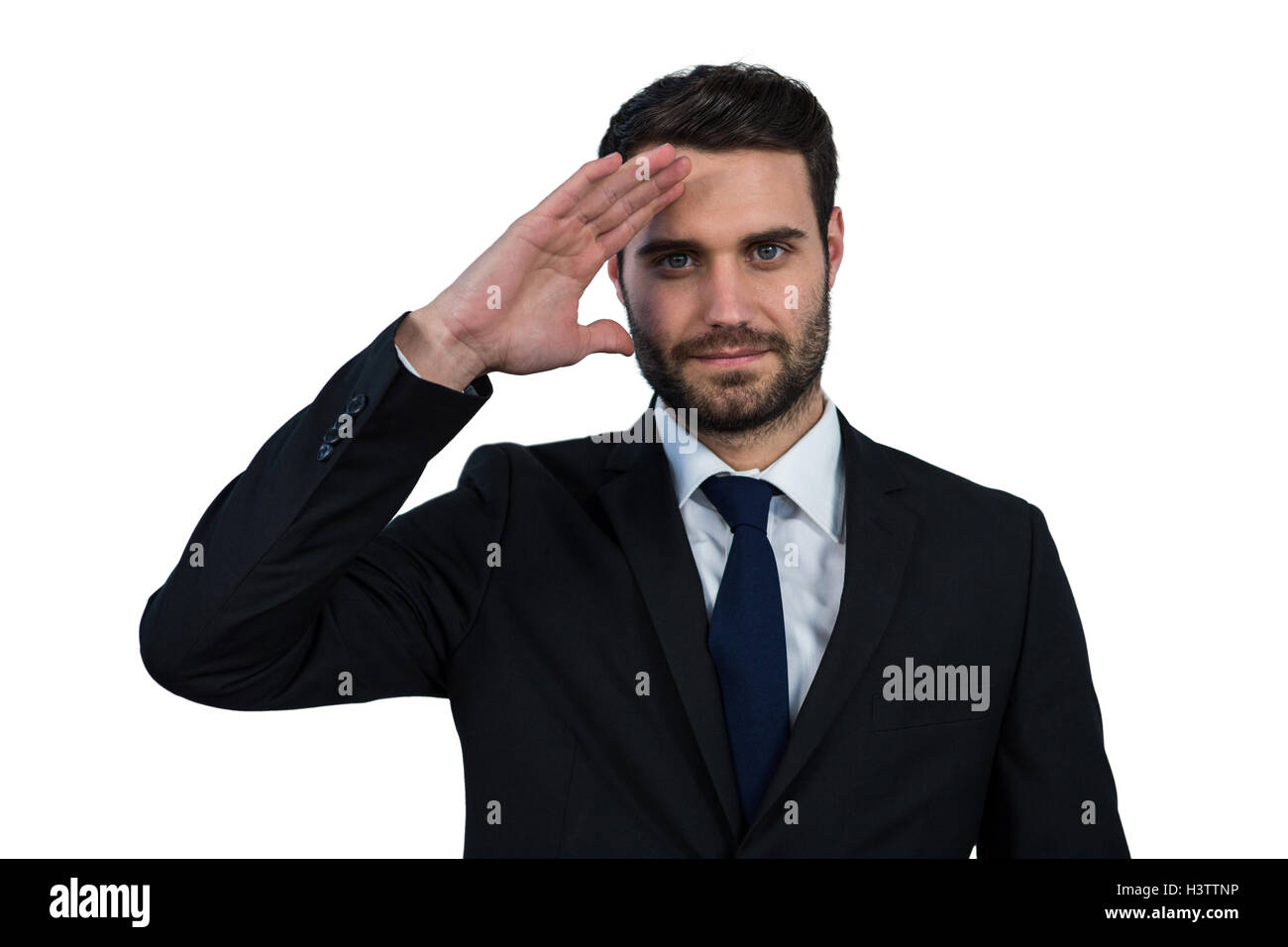 Businessman saluting against white background Stock Photo - Alamy