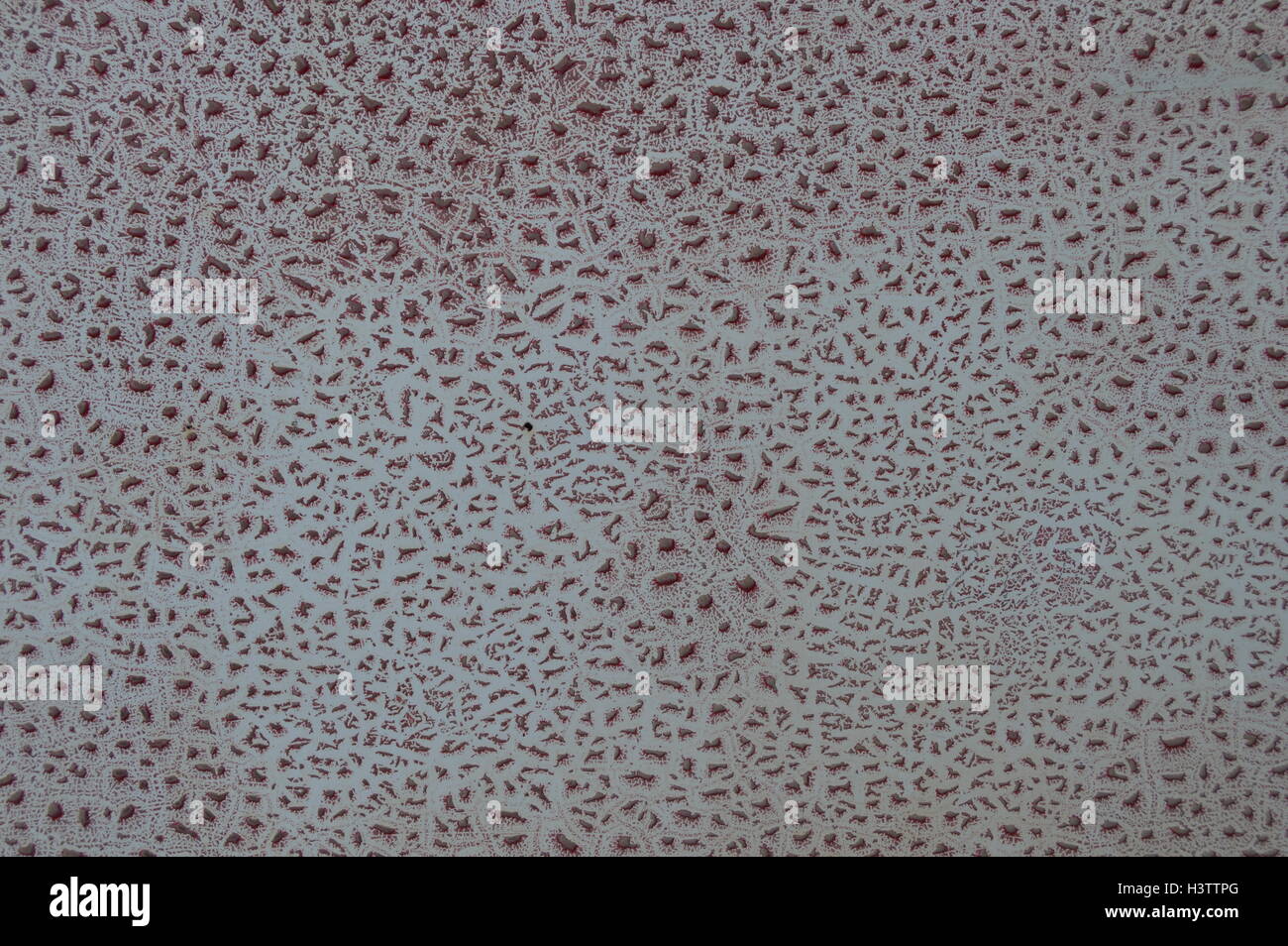 Sheet metal with red dots. Photo of a sheet metal with a red background ...