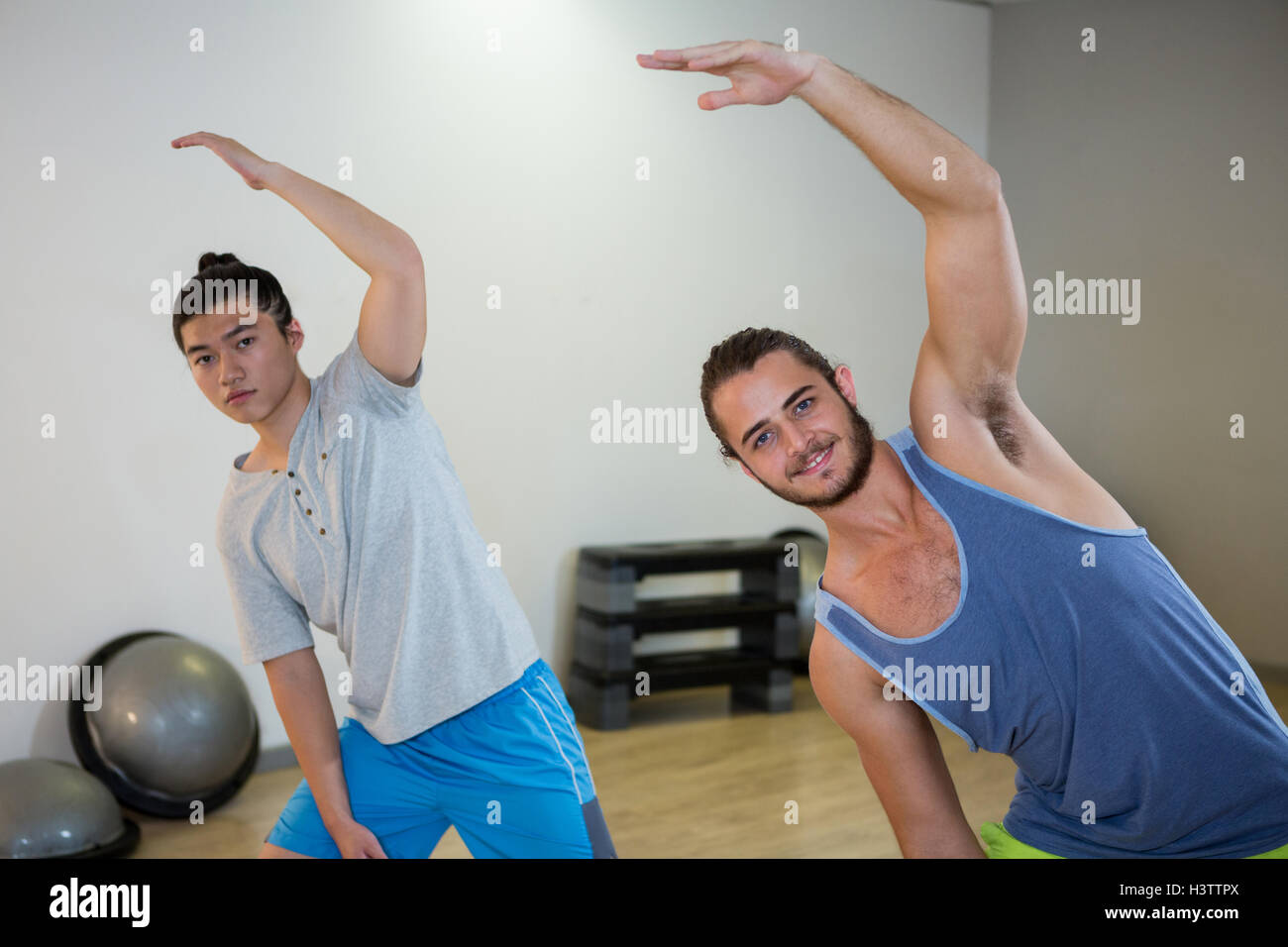 Smiling two men doing aerobic exercise Stock Photo - Alamy