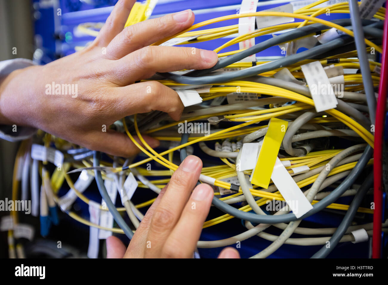 Technician checking cables in a rack mounted server Stock Photo - Alamy